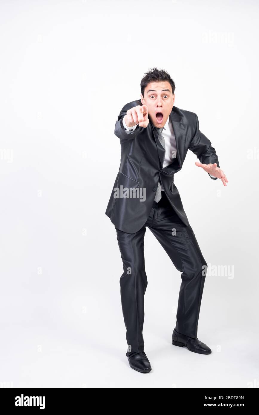 Man in suit pointing in front with index finger. White background, full ...