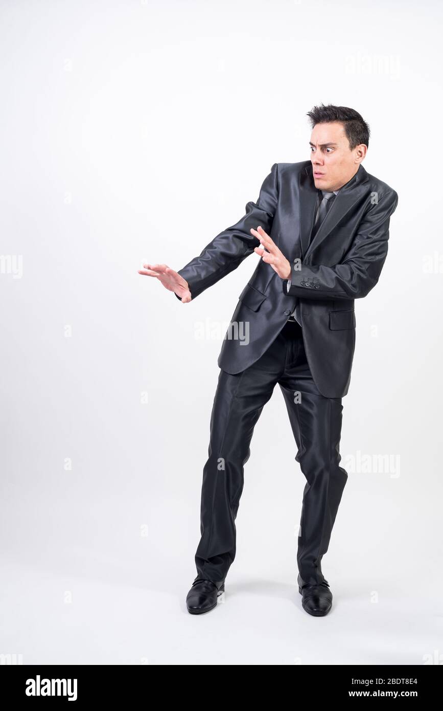 Scared man in suit on white background, full body Stock Photo - Alamy