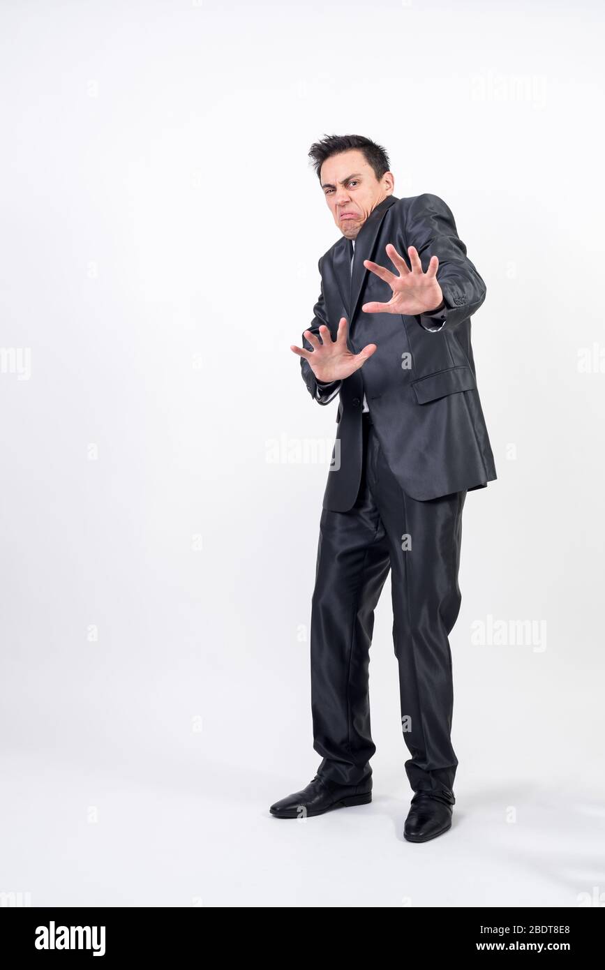 Disgusted man in suit retreating, on white background. Full body Stock ...