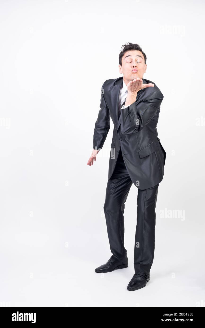 Man in suit throwing a kiss. White background, full body Stock Photo ...