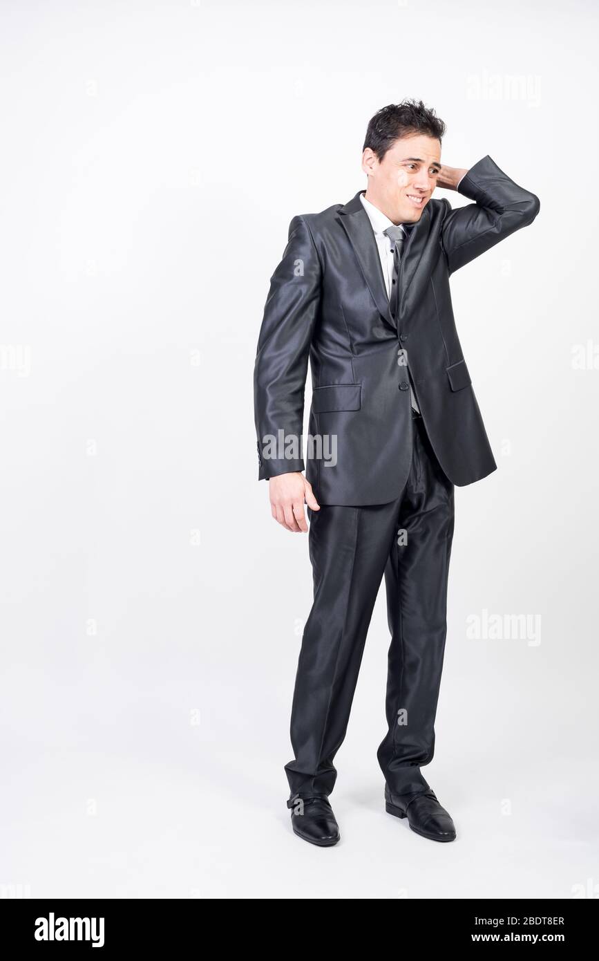 Shy man in suit. White background, full body Stock Photo - Alamy