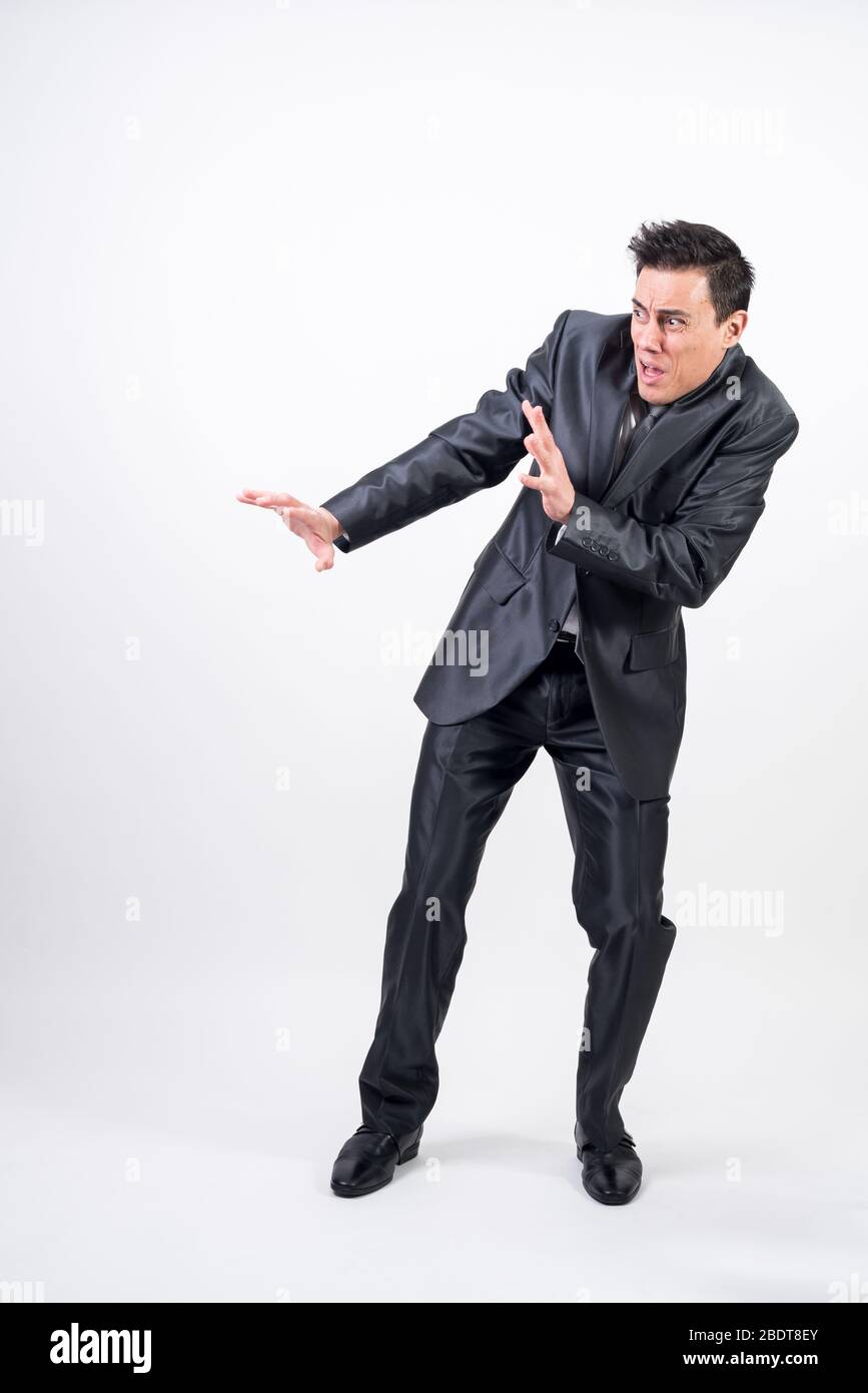 Scared man in suit on white background, full body Stock Photo - Alamy