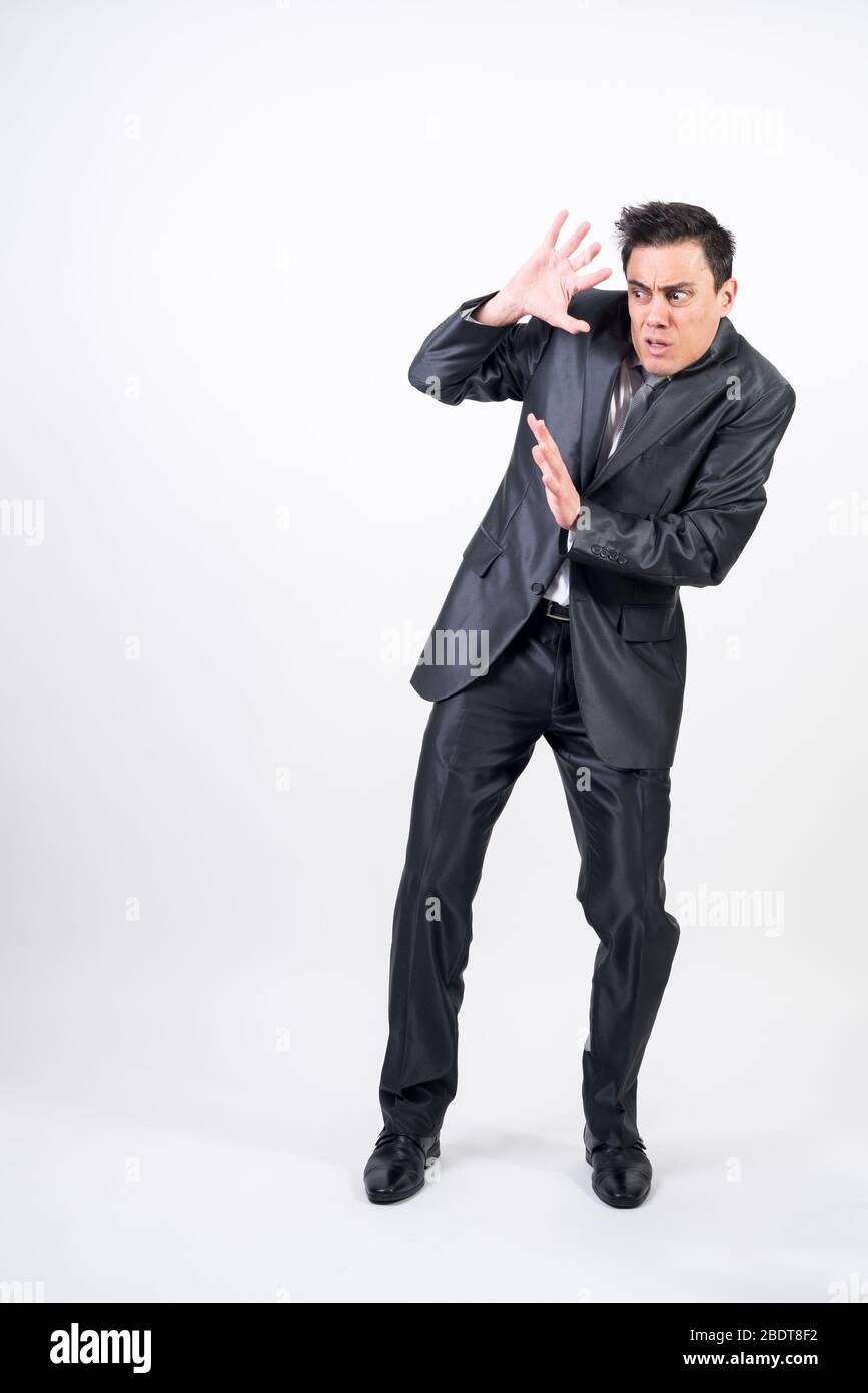 Scared man in suit on white background, full body Stock Photo - Alamy