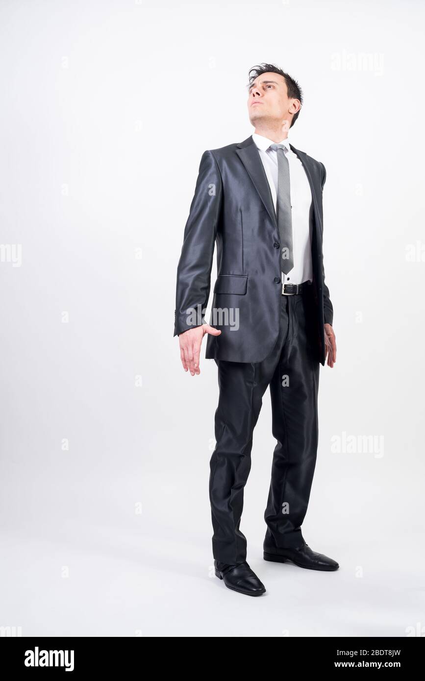 Self-confident man in suit. White background, full body Stock Photo - Alamy