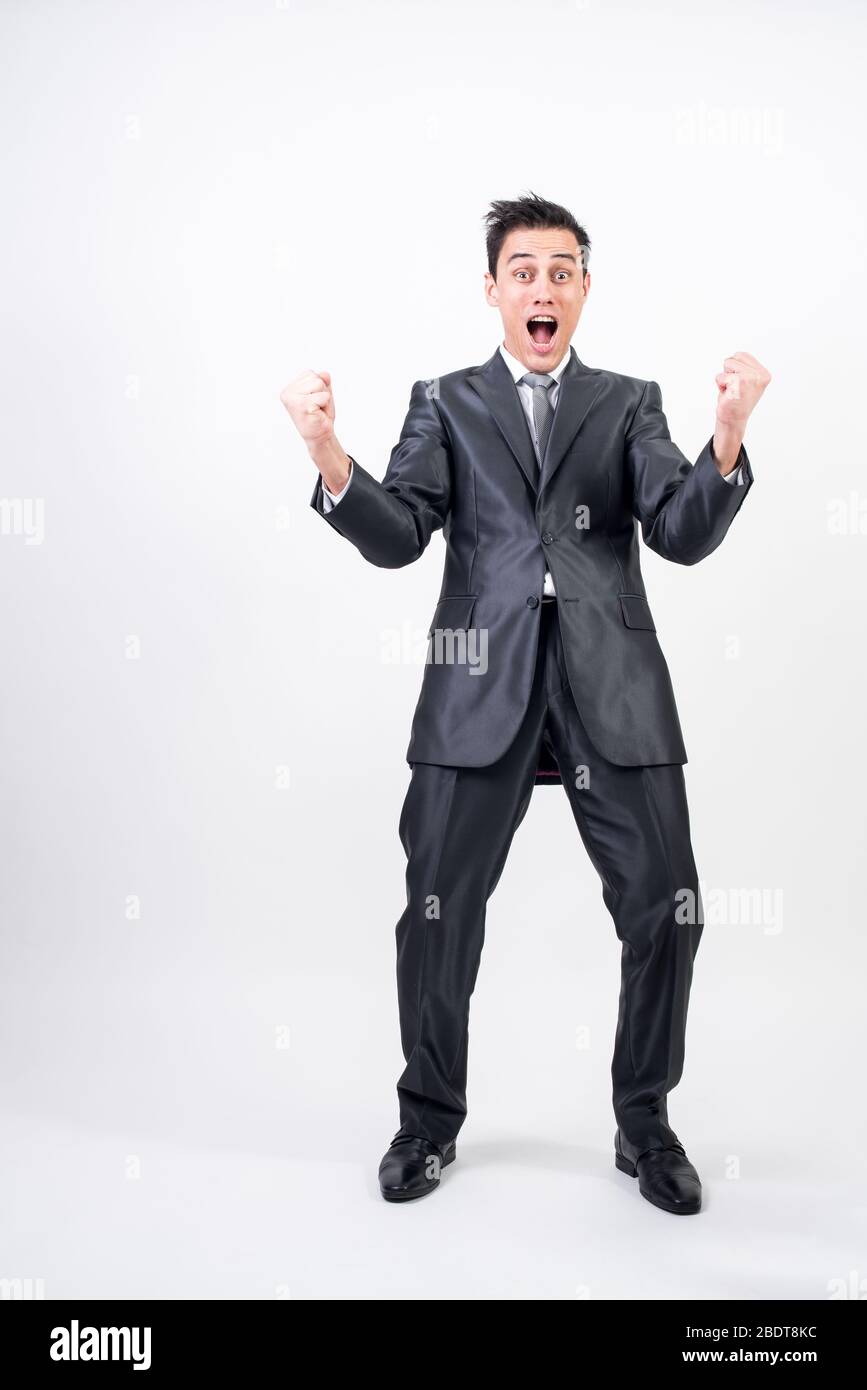 Euphoric man in suit celebrating something. White background. Full body ...