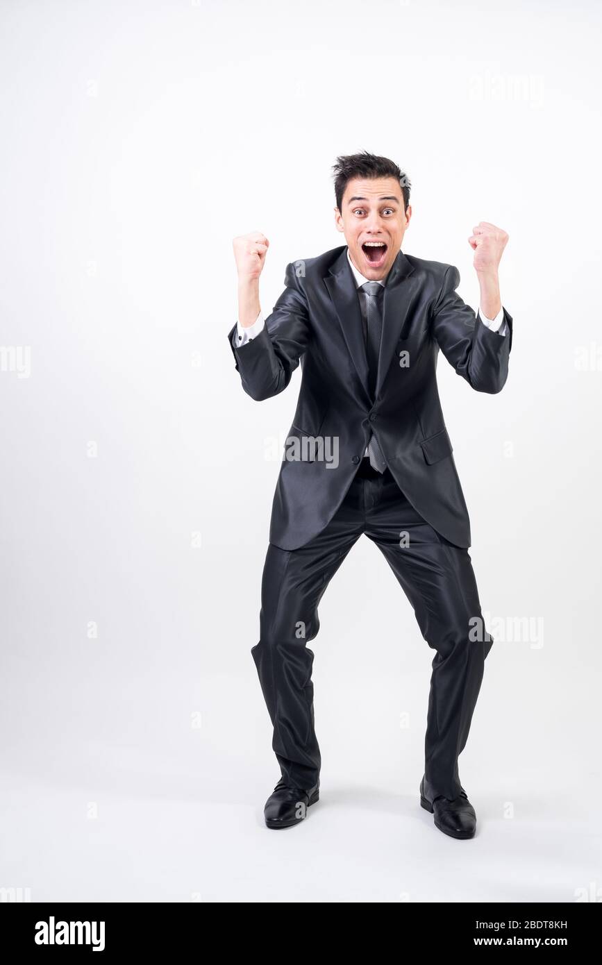 Euphoric man in suit celebrating something. White background. Full body ...