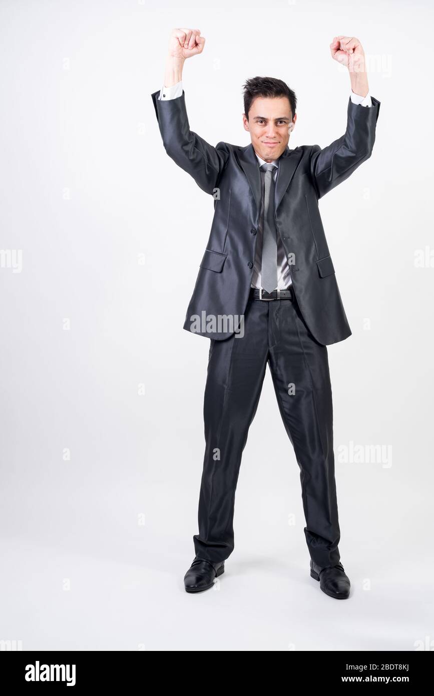 Euphoric man in suit celebrating something. White background. Full body ...