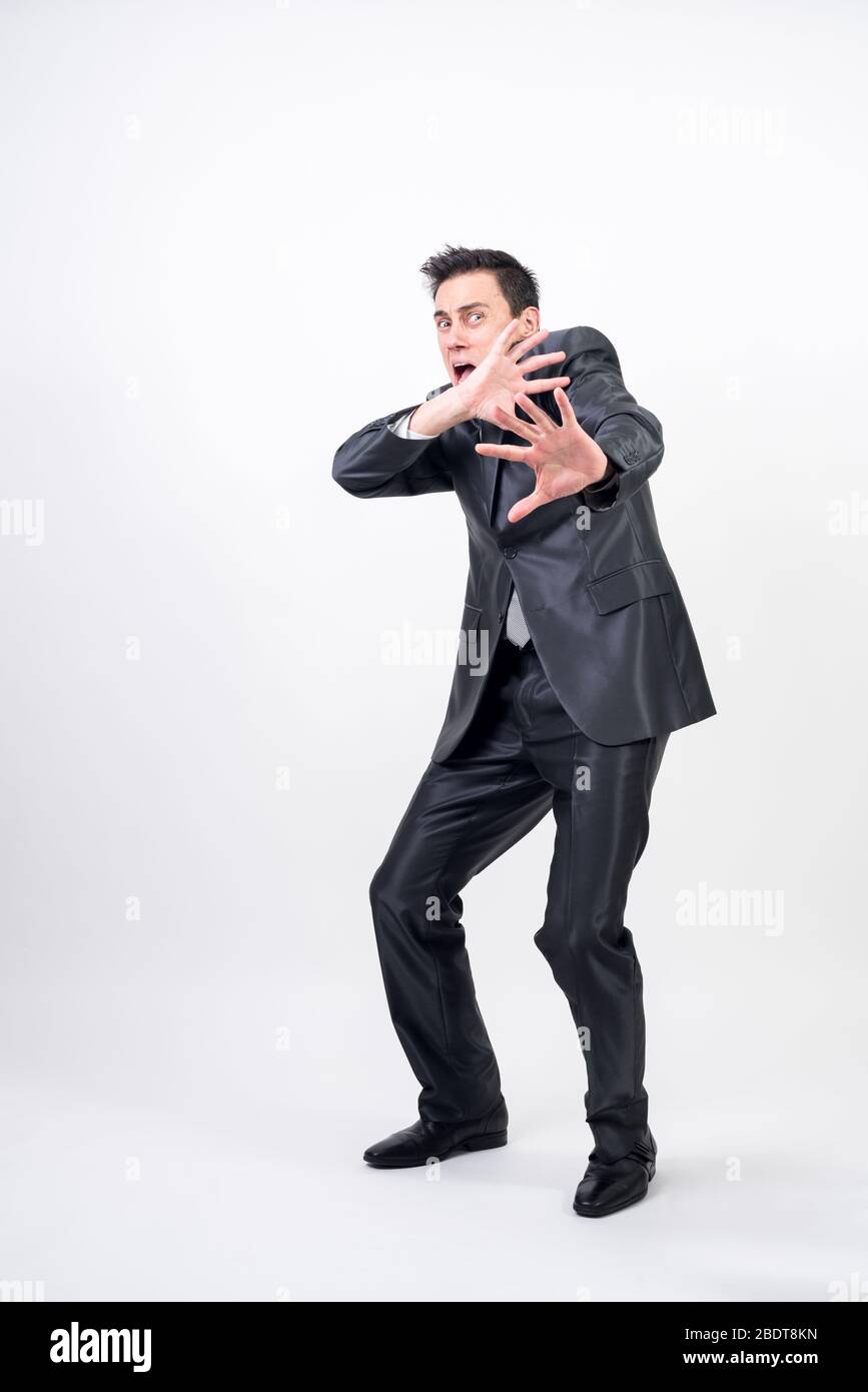 Scared man in suit on white background, full body Stock Photo - Alamy