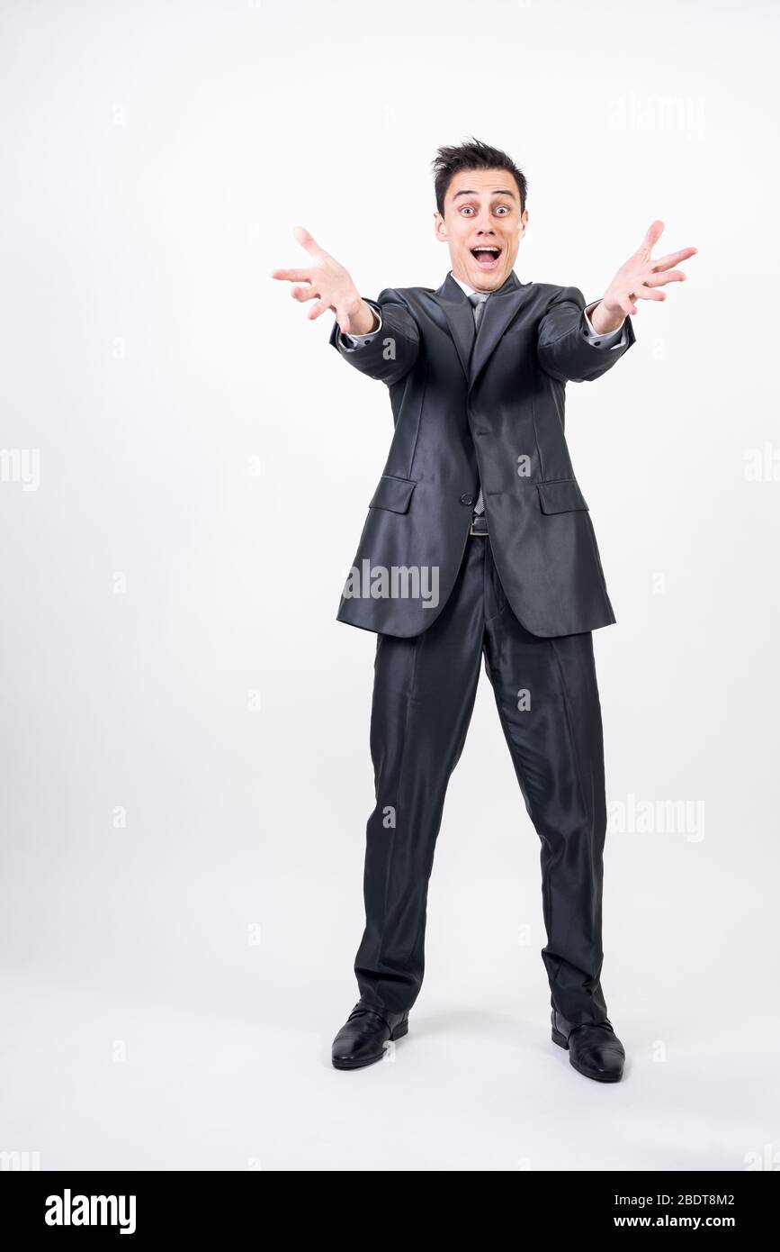 Euphoric man in suit celebrating something. White background. Full body ...
