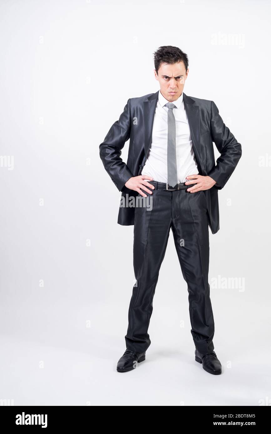 Challenging man in suit. White background. Full body Stock Photo - Alamy