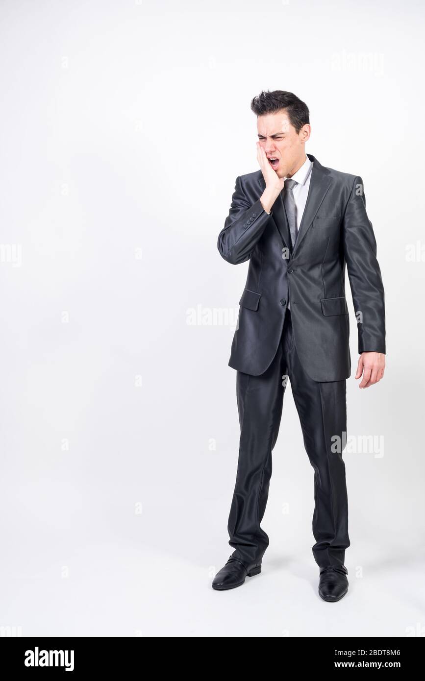 Sore man in suit. White background. Full body Stock Photo - Alamy