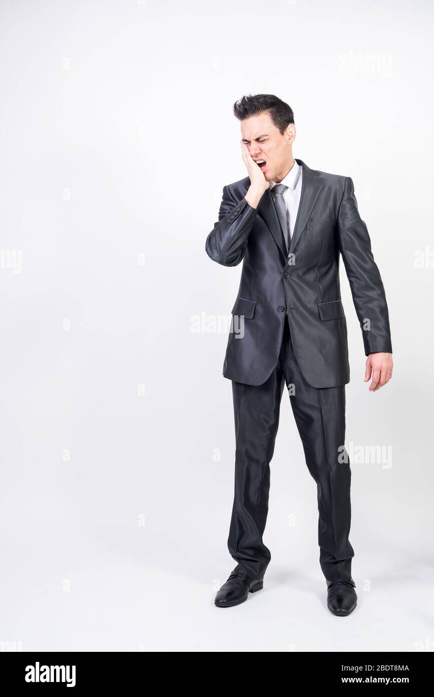 Sore man in suit. White background. Full body Stock Photo - Alamy