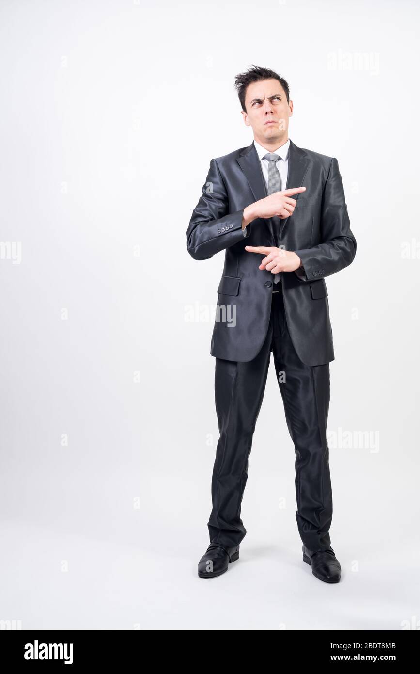 Confused man in suit. White background. Full body Stock Photo - Alamy