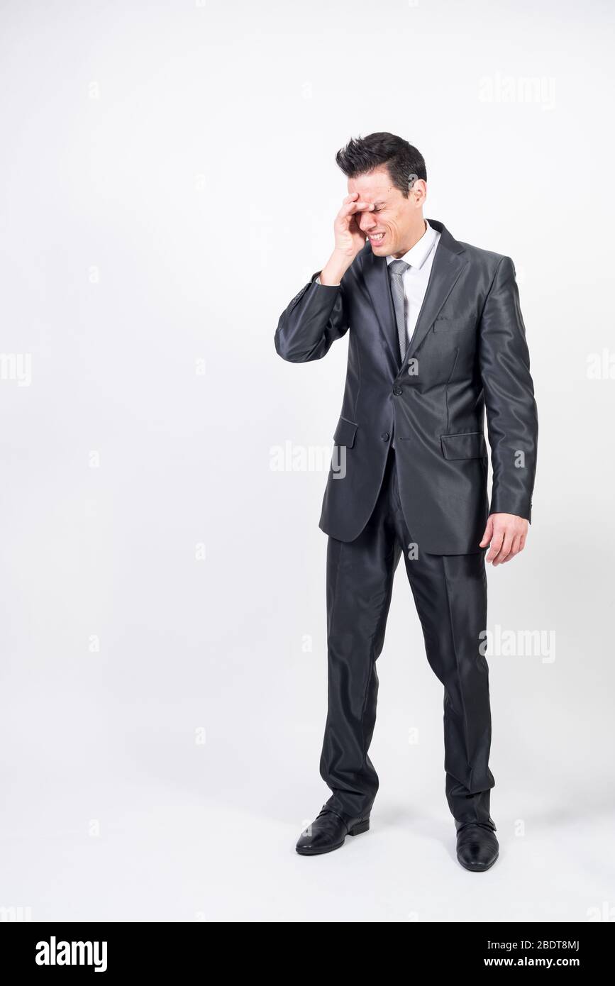 Sore man in suit. White background. Full body Stock Photo - Alamy