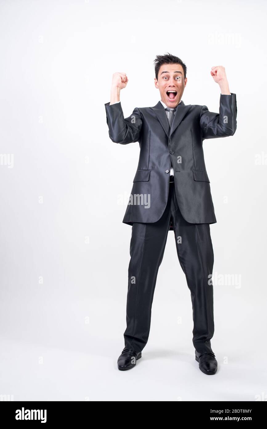 Euphoric man in suit celebrating something. White background. Full body ...