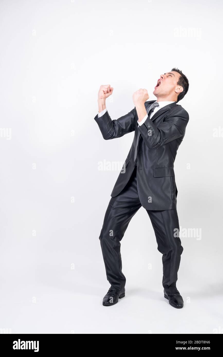 Euphoric man in suit celebrating something. White background. Full body ...