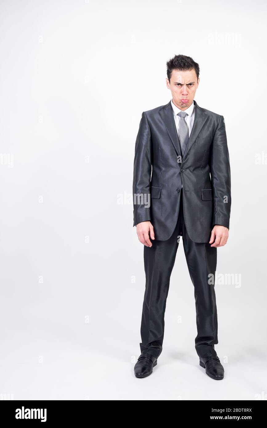 Angry man in suit. white background, full body Stock Photo - Alamy