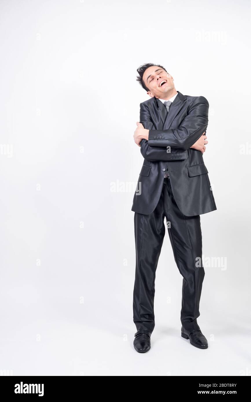 Man in suit in love hugging himself. white background, full body Stock ...