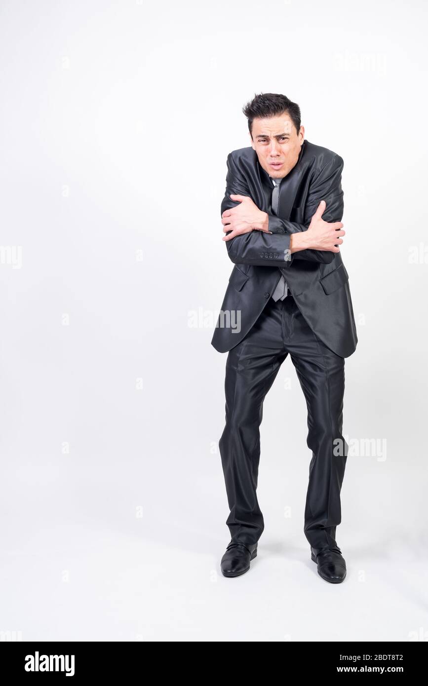 Man in suit getting very cold surrounding his body with his arms. white ...