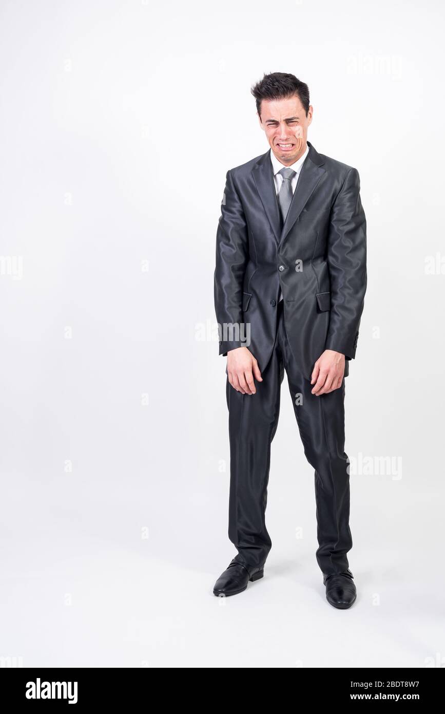 Crying man in suit. white background, full body Stock Photo - Alamy