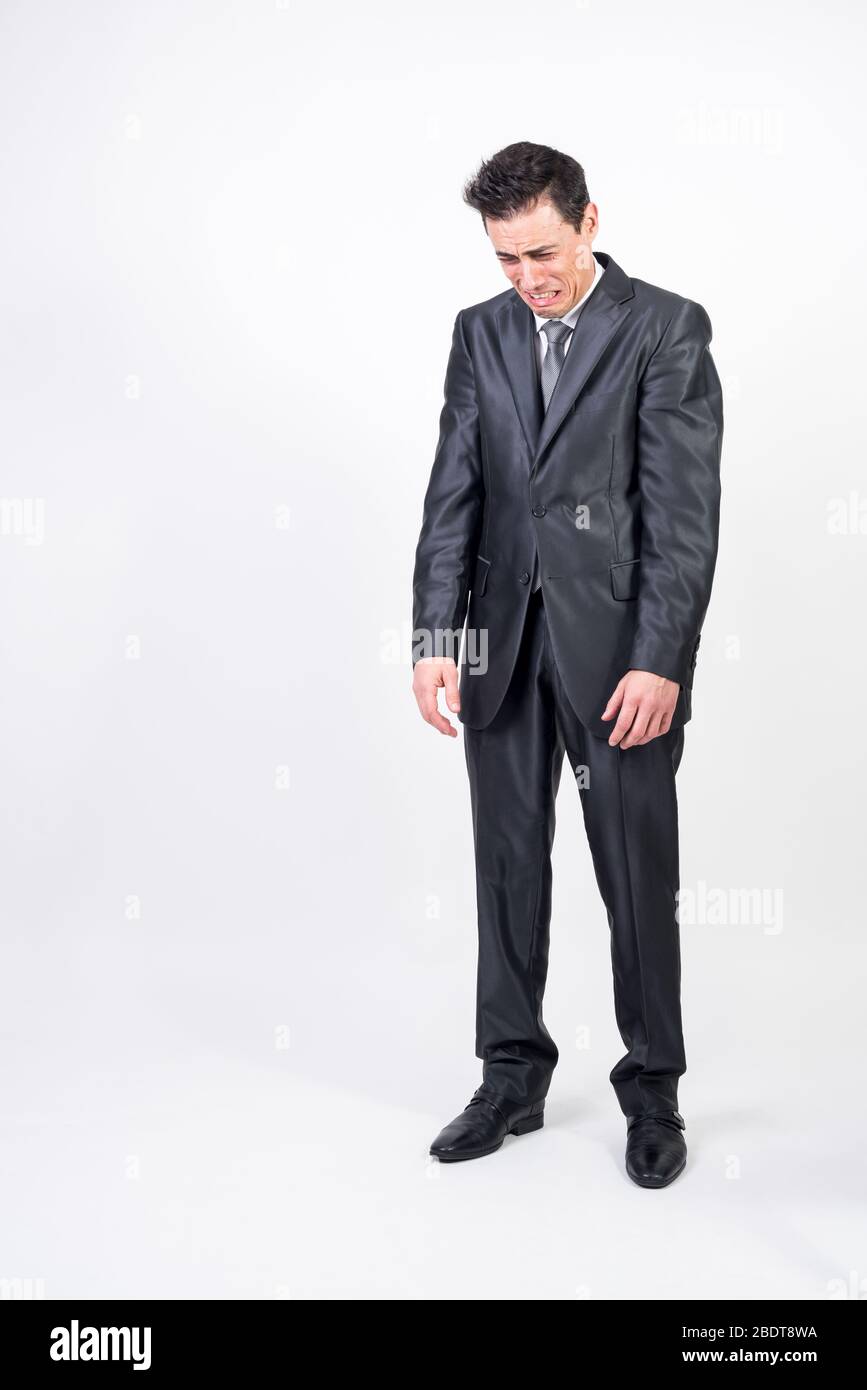 Crying man in suit. white background, full body Stock Photo - Alamy