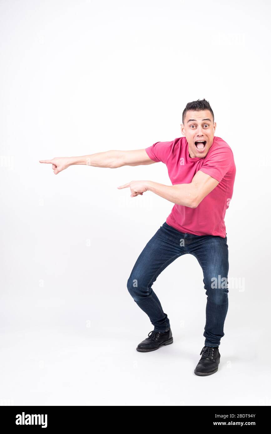 Surprised man pointing to copy space. White background, full body Stock ...