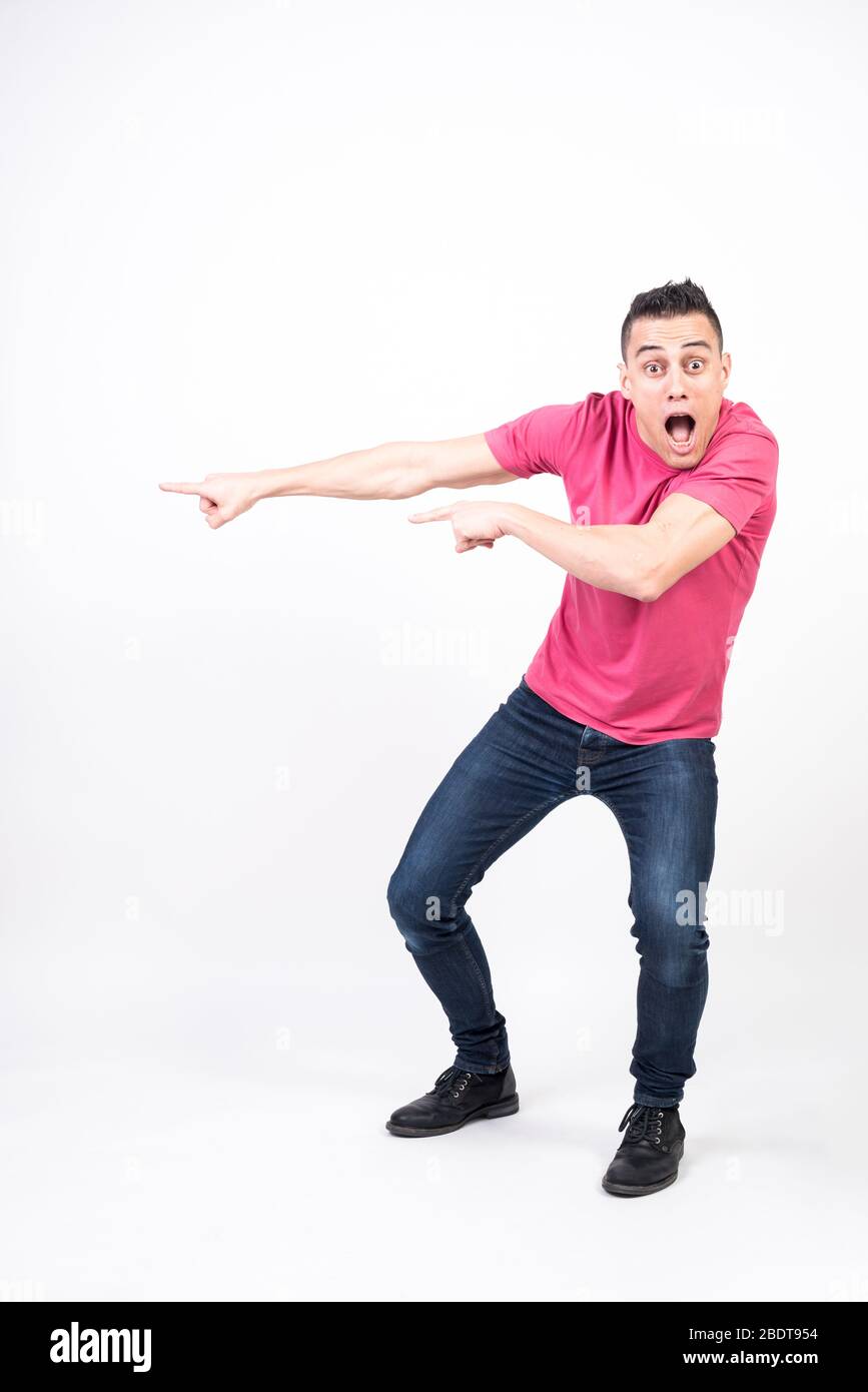 Surprised man pointing to copy space. White background, full body Stock ...