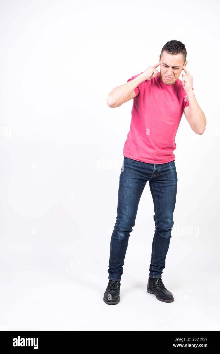 Man disgusted by noise. White background, full body Stock Photo - Alamy