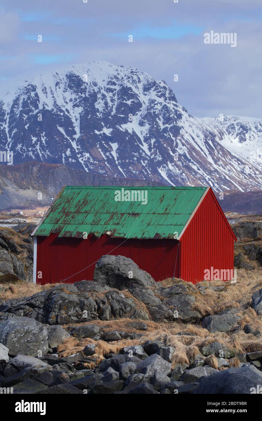 Traditional barn beside mountain lake near Leknes in the Lofoten ...