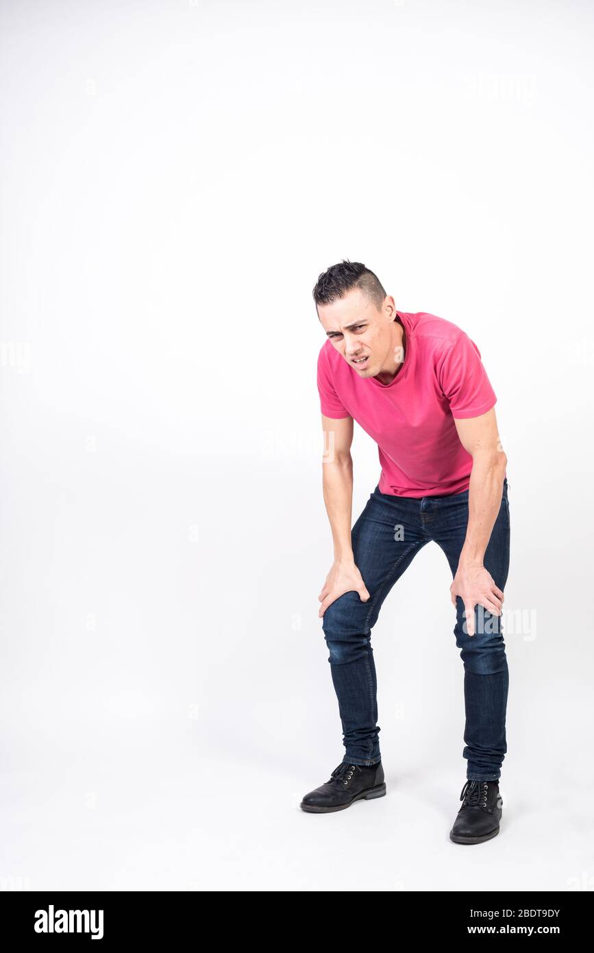 tired man wiping the sweat from his forehead with the back of his hand ...