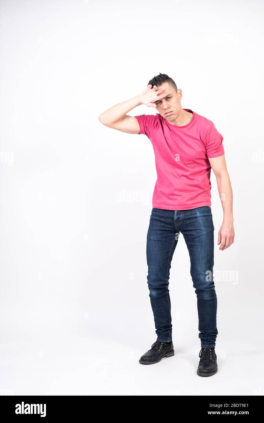 tired man wiping the sweat from his forehead with the back of his hand ...