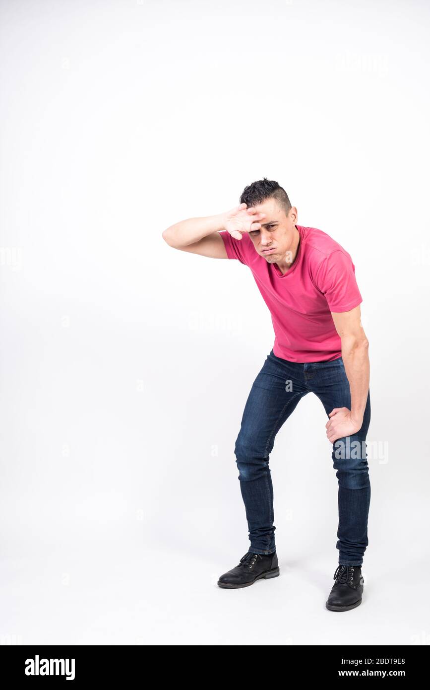 tired man wiping the sweat from his forehead with the back of his hand ...