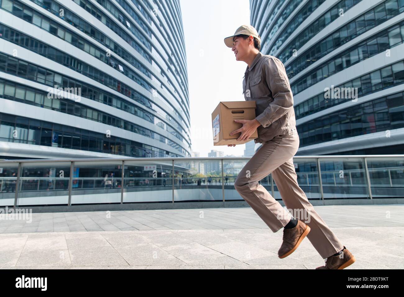 Running with a parcel Courier Stock Photo - Alamy