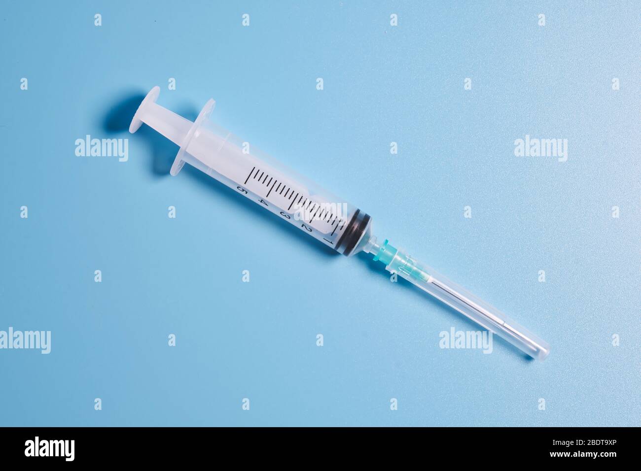 Syringe, injection syringe on isolated blue surface Stock Photo - Alamy