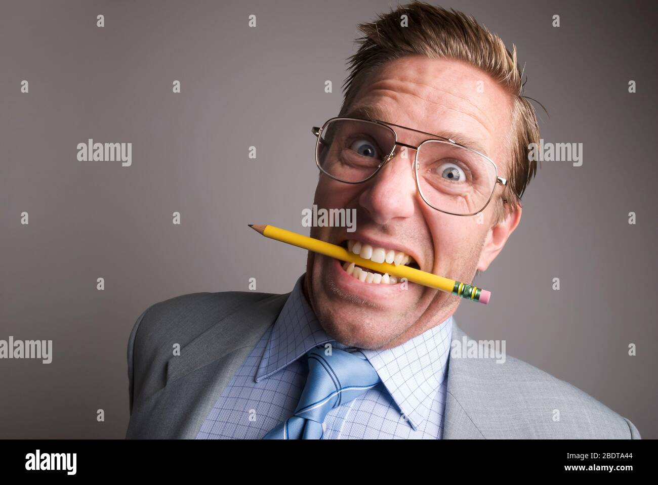 Angry man biting pencil hi-res stock photography and images - Alamy