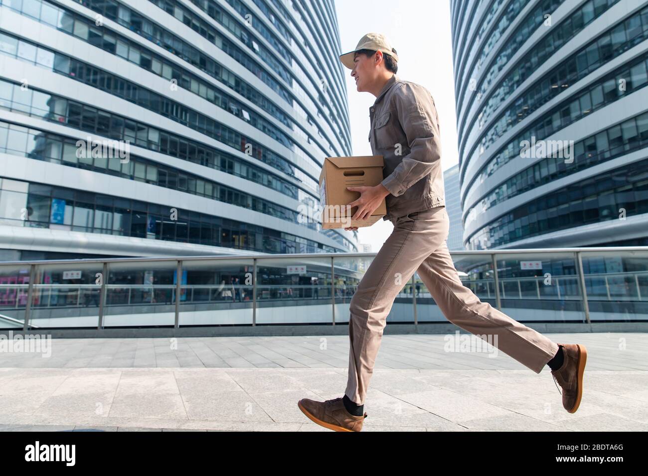 Running with a parcel Courier Stock Photo - Alamy