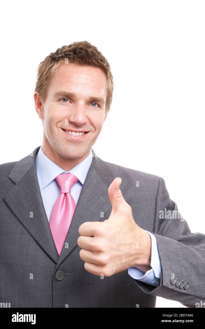 Cheerful businessman giving a smiling thumbs up standing against white ...