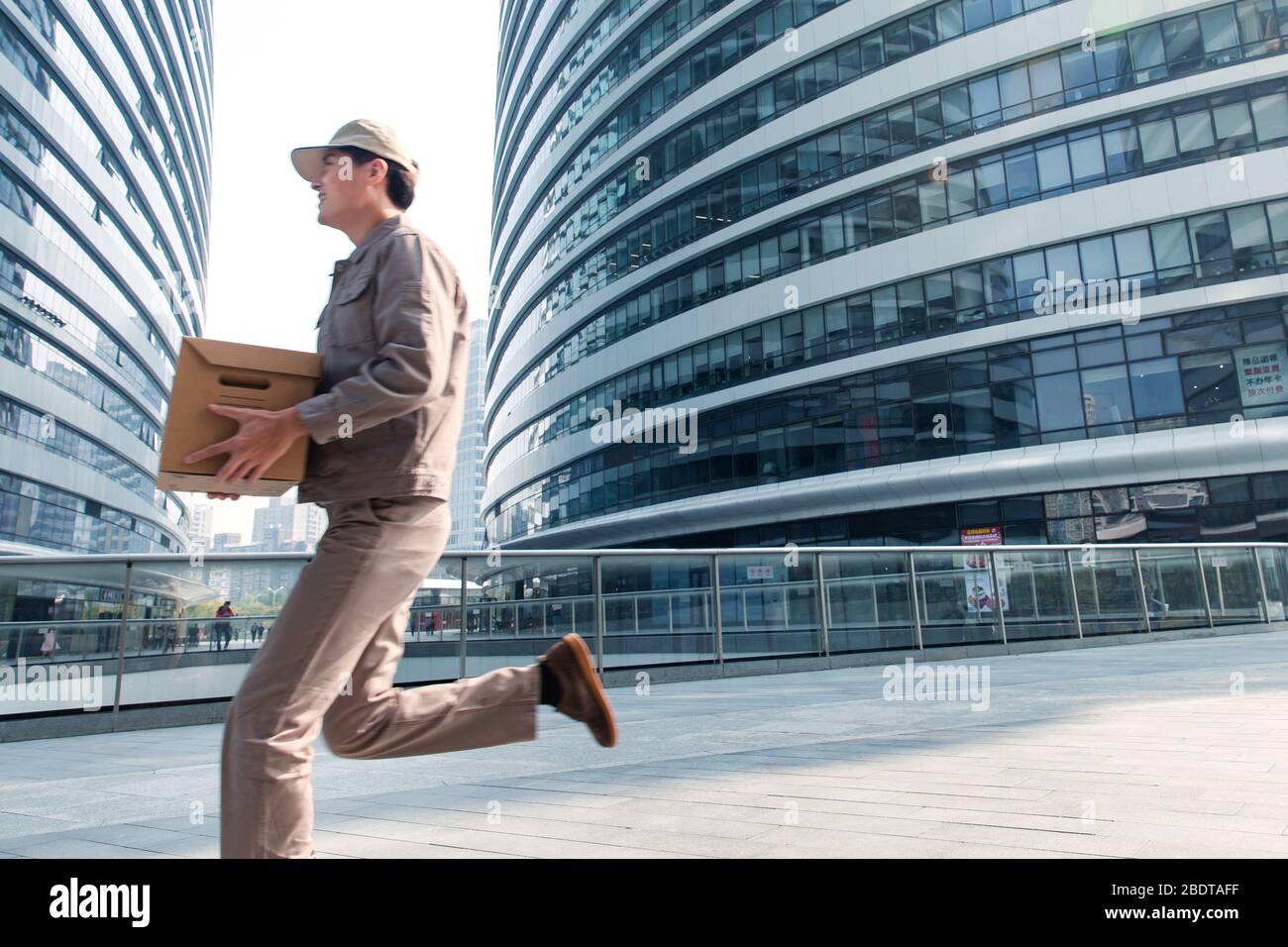 Office men running street hi-res stock photography and images - Alamy