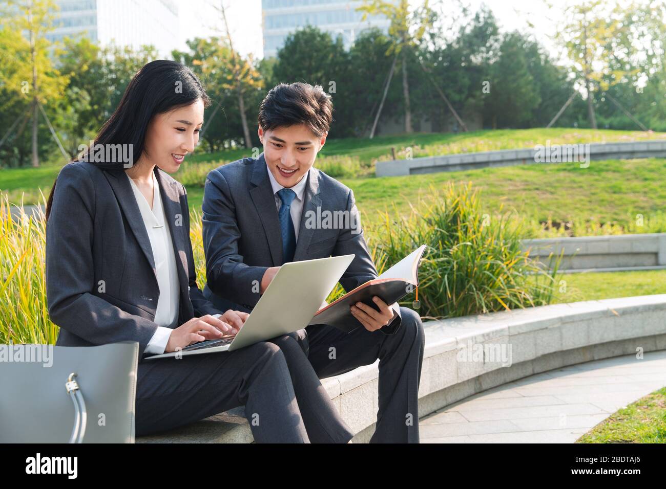 Young business people use computers in the outdoor work Stock Photo - Alamy