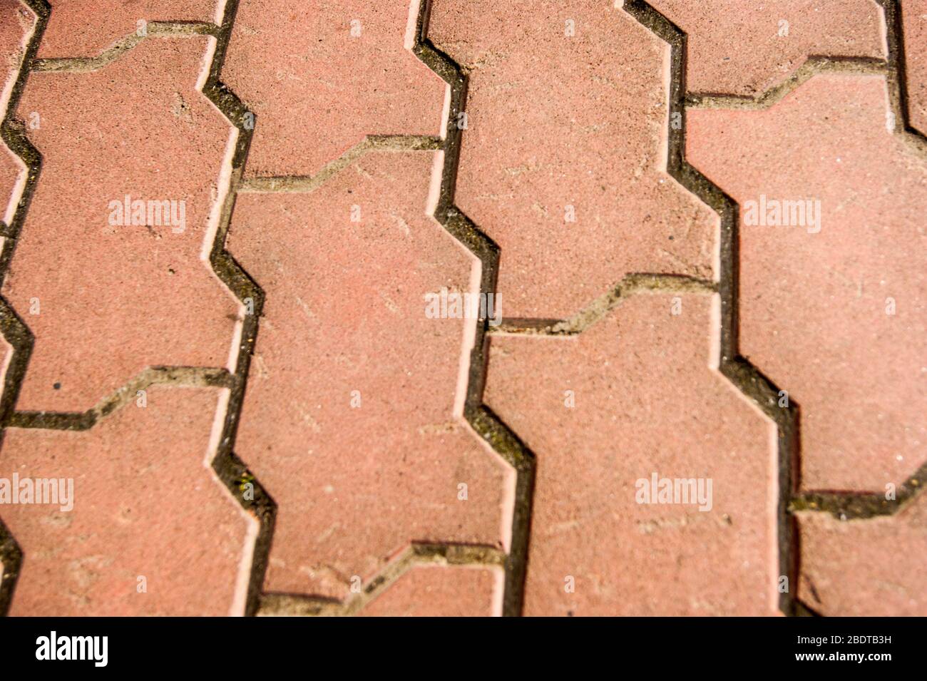 Texture of a footpath paved with red brick paving slabs. Pattern ...