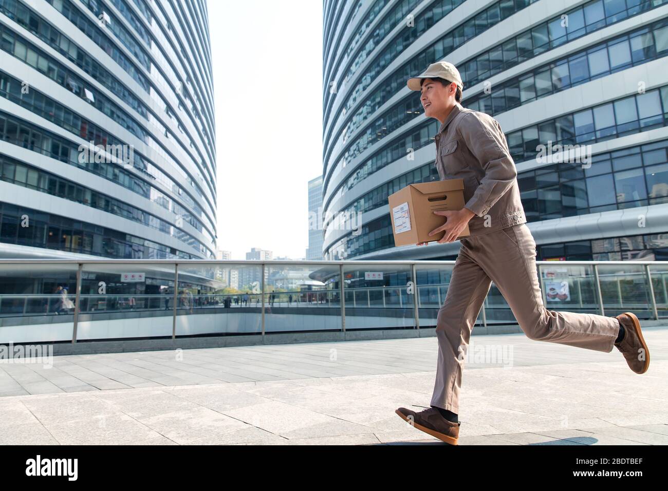 Running with a parcel Courier Stock Photo - Alamy