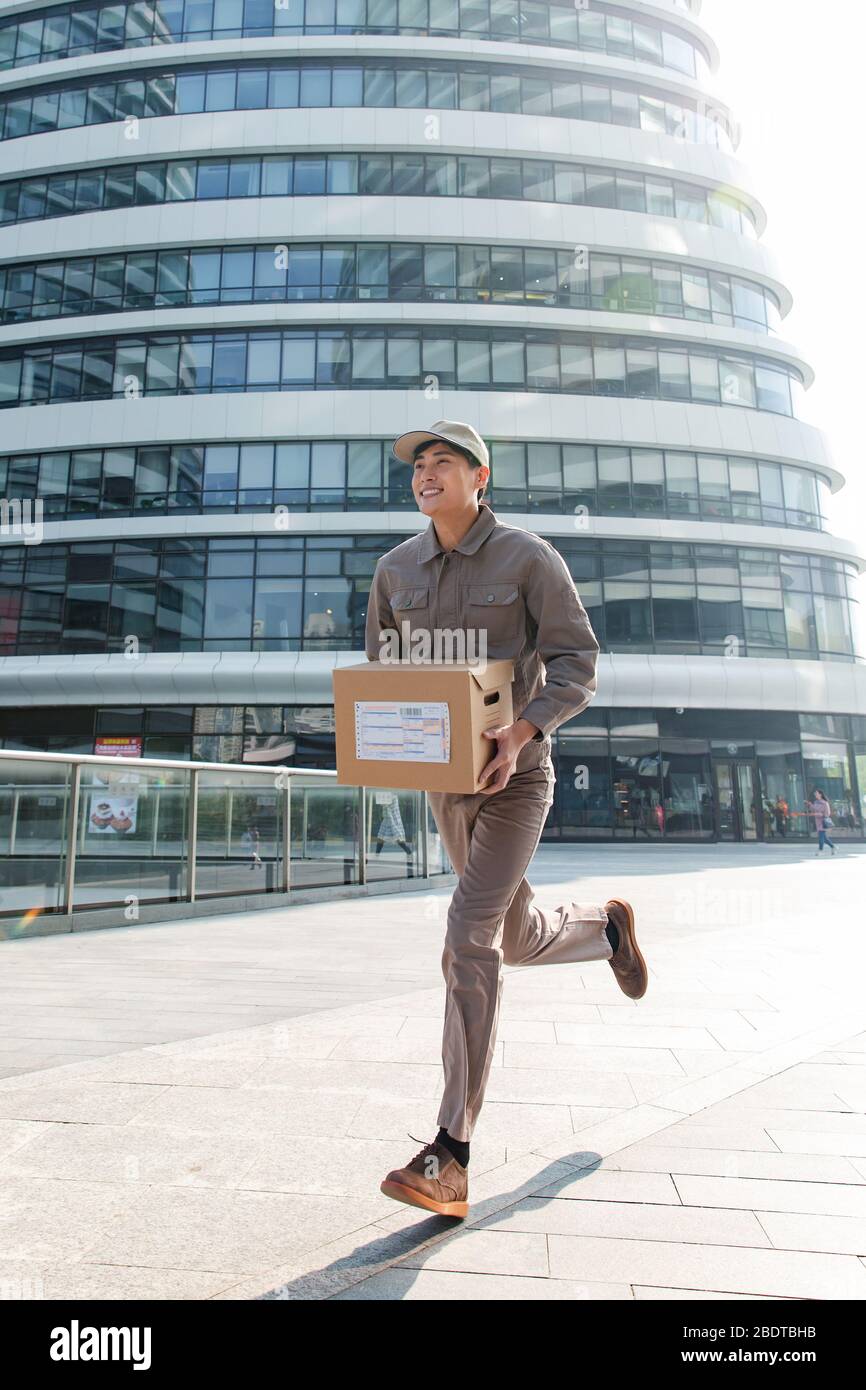 Running with a parcel Courier Stock Photo - Alamy