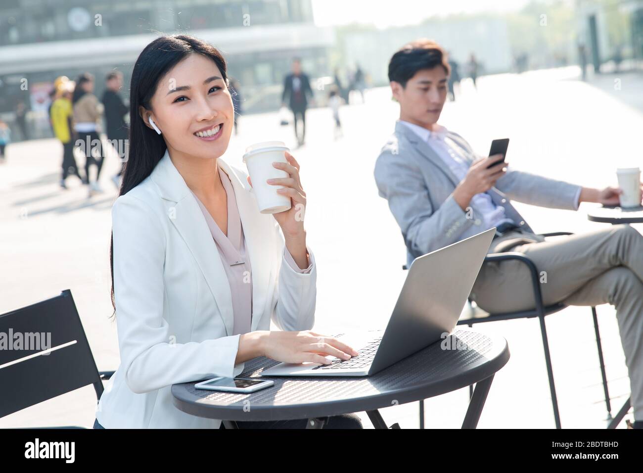 Business people use computers in the open-air cafe Stock Photo - Alamy