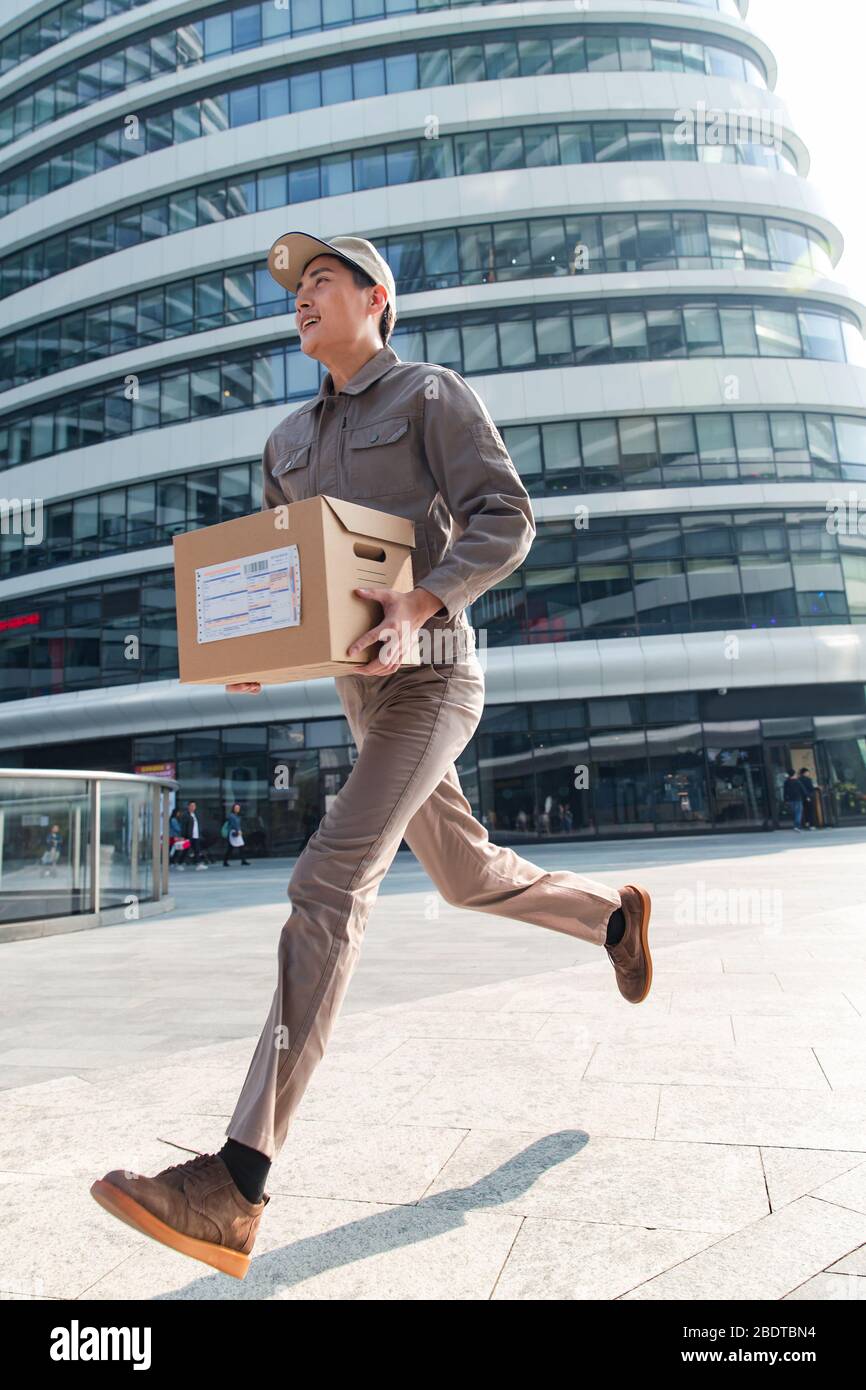 Running with a parcel Courier Stock Photo - Alamy