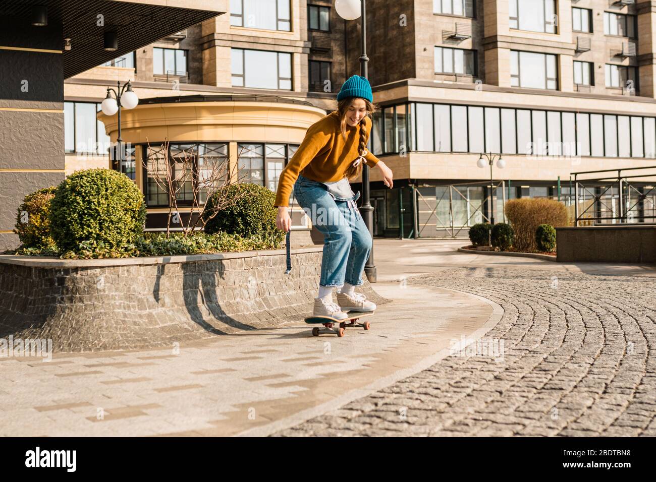 Skateboarding Woman In The City. Skater girl in denim is riding her ...
