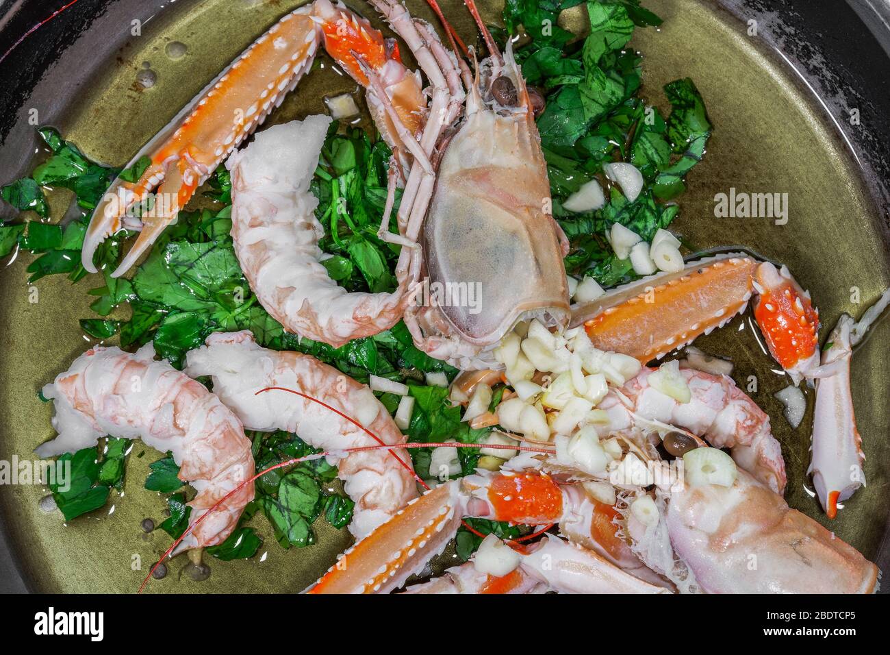 Fresh seafood langoustine top view closeup, prepared on kitchen pan ...