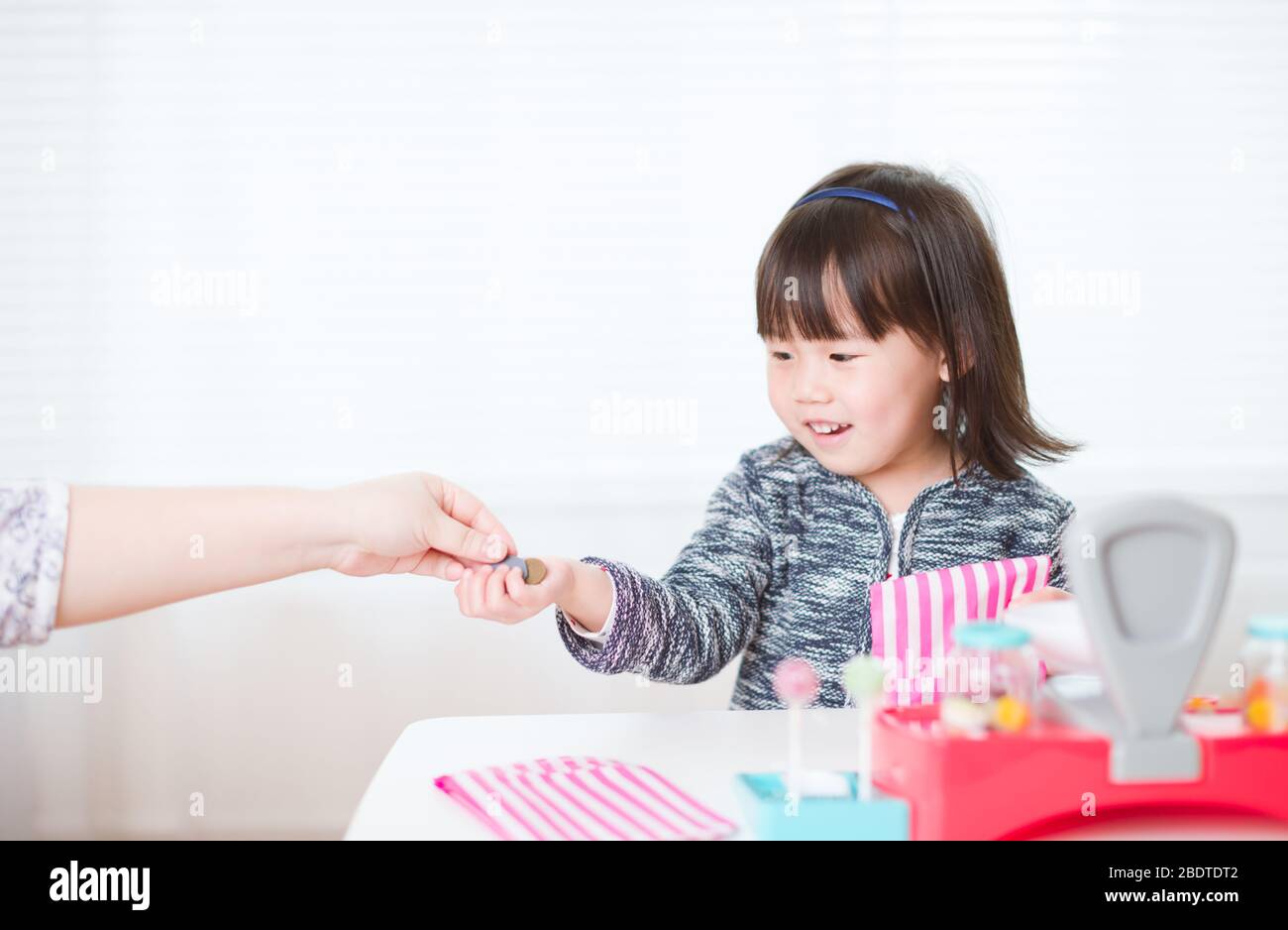 toddler girl pretend play sweet shop keeper at home Stock Photo - Alamy