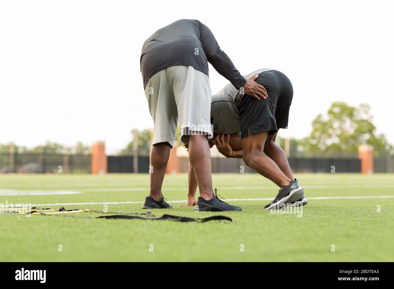 American Football coach training a young athlete Stock Photo - Alamy