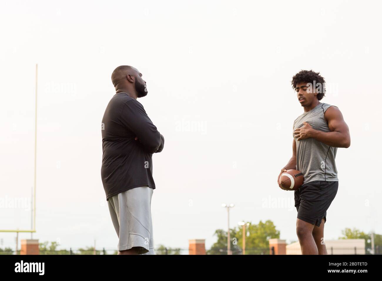 American Football coach training a young athlete Stock Photo - Alamy