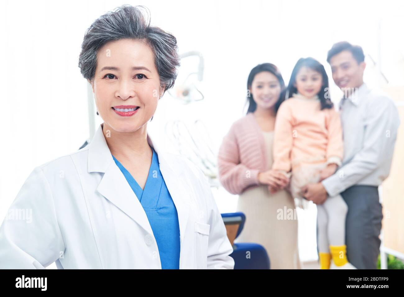 Female doctors and patients families Stock Photo - Alamy